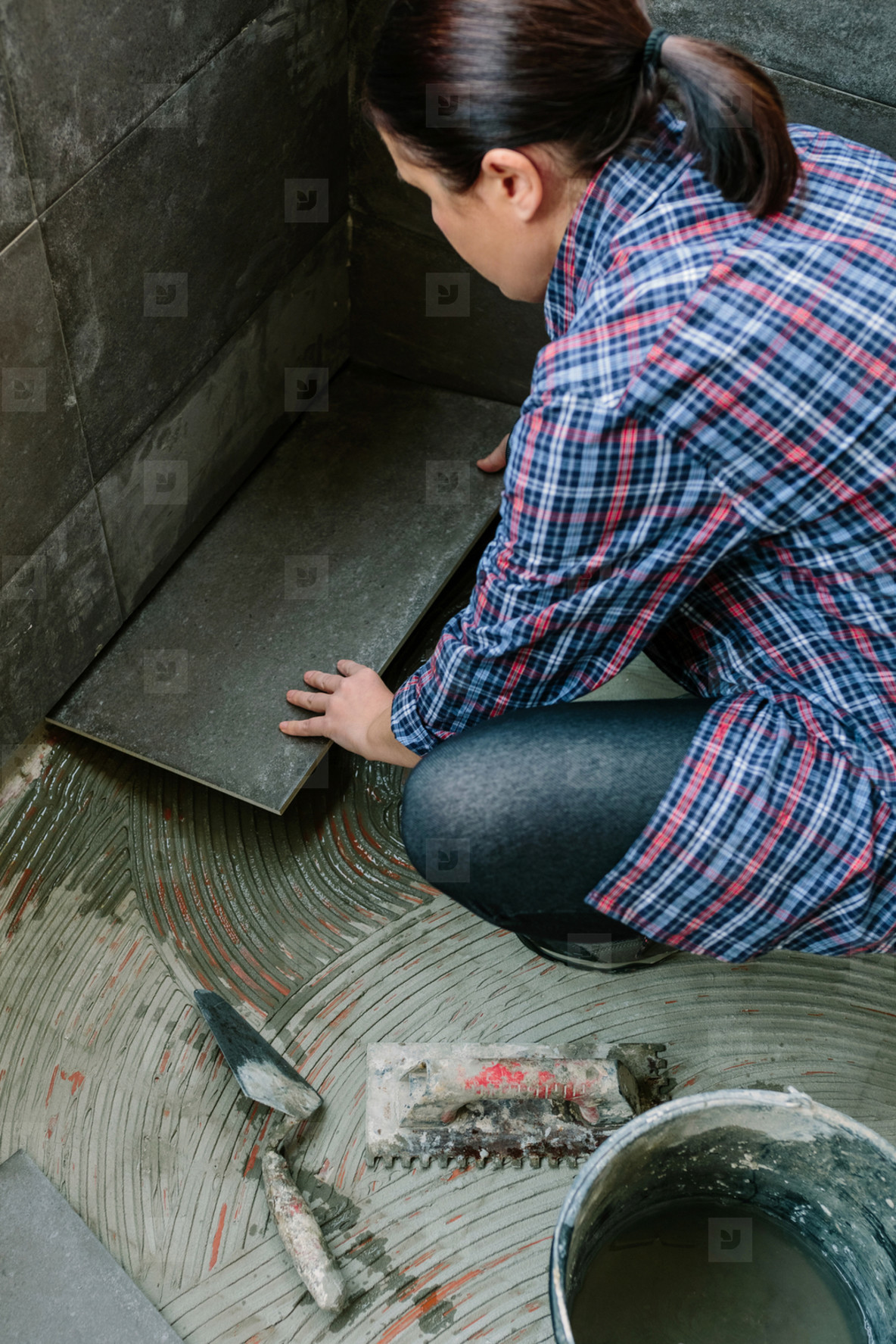 Female builder laying a new tile floor stock photo (209305 ...